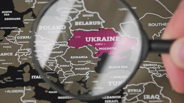 Ukraine on the world map under magnifying glass. War in Ukraine ...