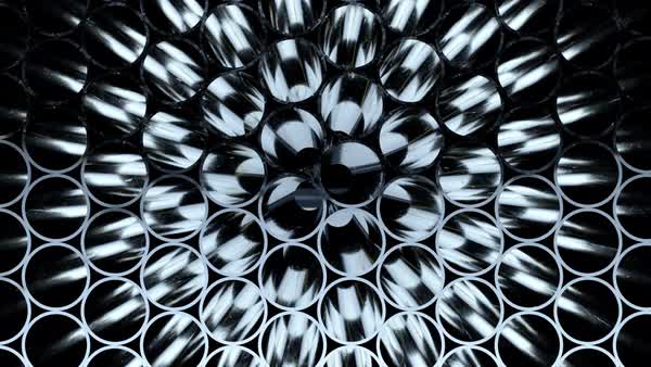 Rows of Metal Pipes with reflections and Sun Flares inside. Steel pipes ...