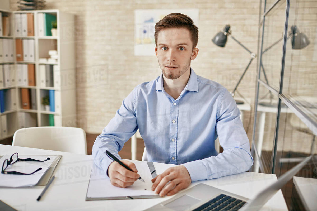 Portrait of young manager working at his desk - Royalty-free Stock ...