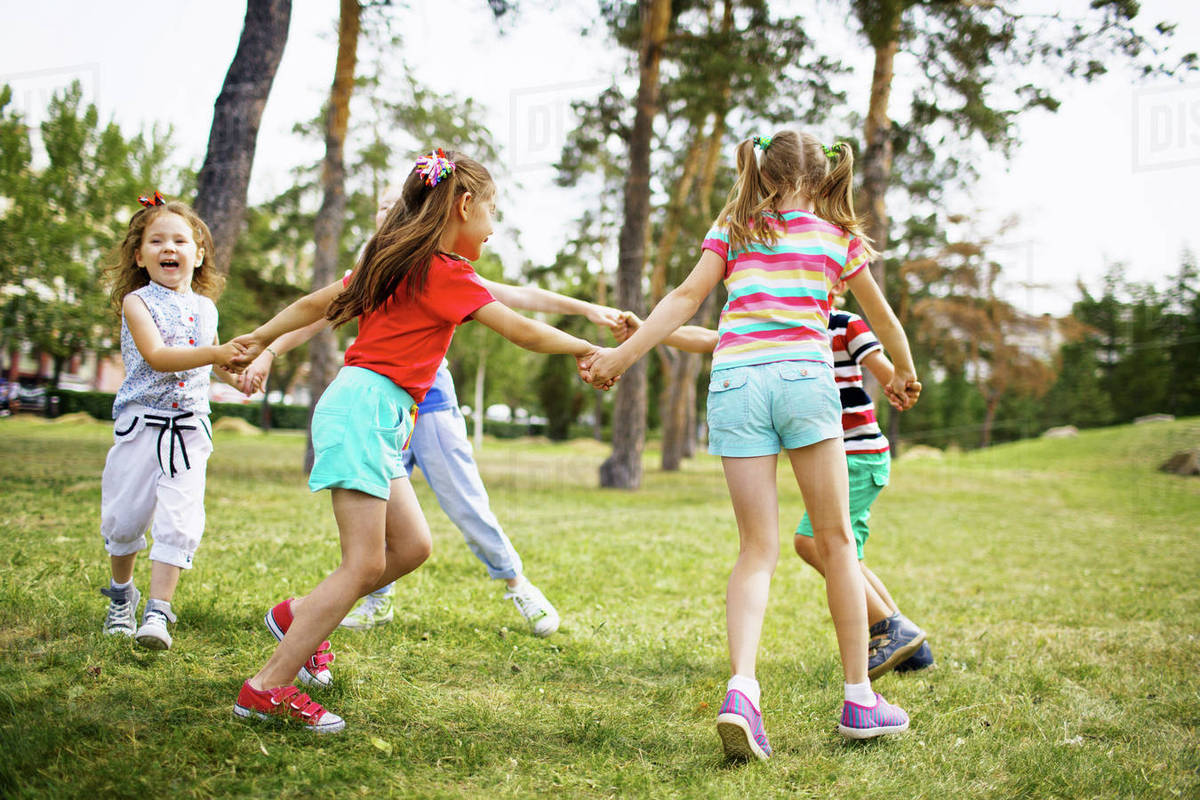 Merry children having round dance on grass - Royalty-free Stock Photo ...