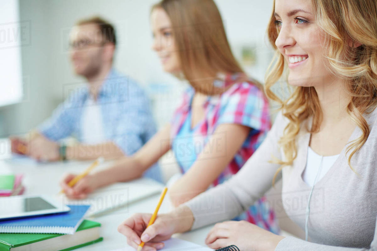 Clever student carrying out written task in college - Stock Photo ...