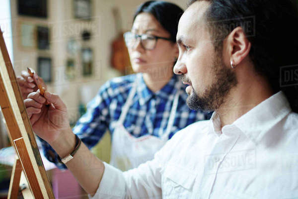 Tutor explaining his student how to draw sketch - Royalty-free Stock ...