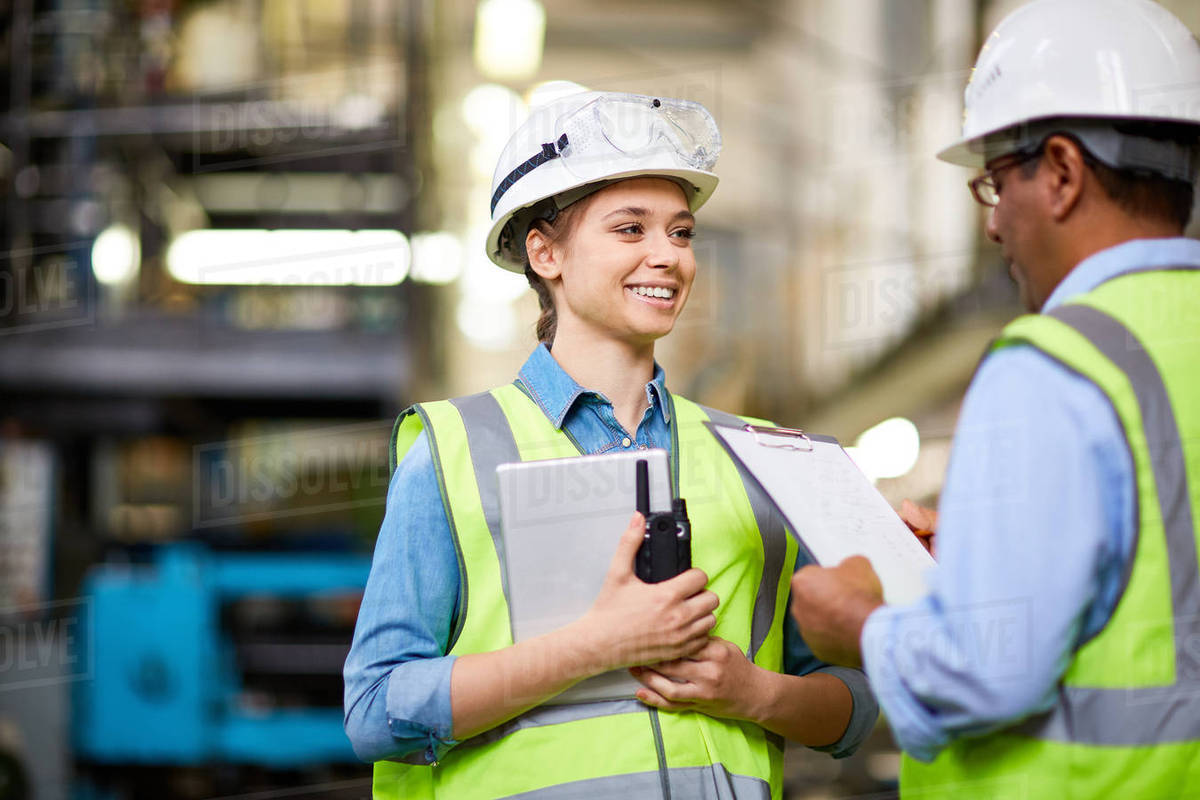 Couple of engineers working in the factory - Stock Photo - Dissolve