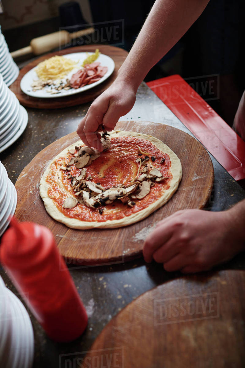 Close-up of chef cooking Italian pizza with mushrooms - Stock Photo ...