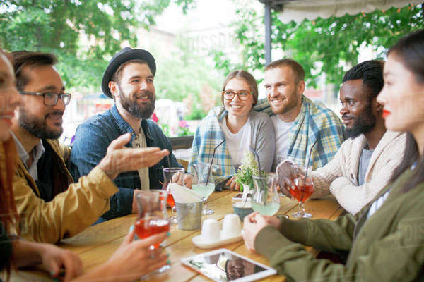 Happy friends talking at leisure - Royalty-free Stock Photo | Dissolve