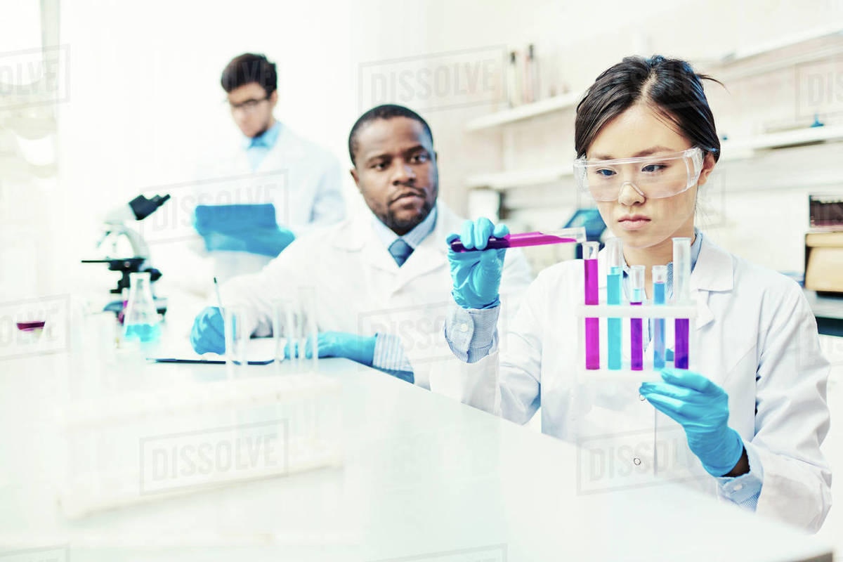 Three scientists working in a laboratory - Royalty-free Stock Photo ...