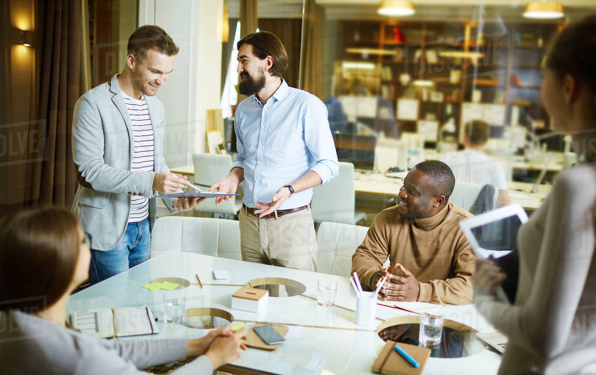 Men talking during meeting in office - Royalty-free Stock Photo | Dissolve