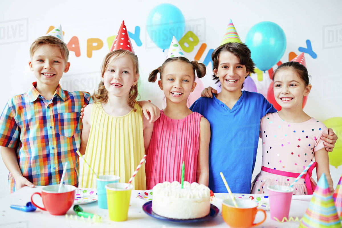 Row of happy kids enjoying birthday party - Royalty-free Stock Photo ...