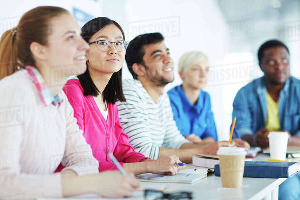 Clever students sitting in row during lecture - Royalty-free Stock ...