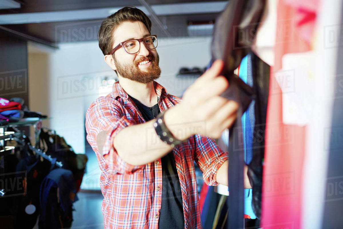 Handsome young man shopping for clothes at shop - Royalty-free Stock ...