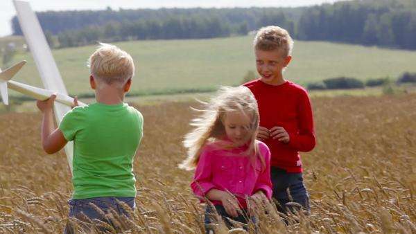 Children playing together in the countryside, little girl being a bit ...