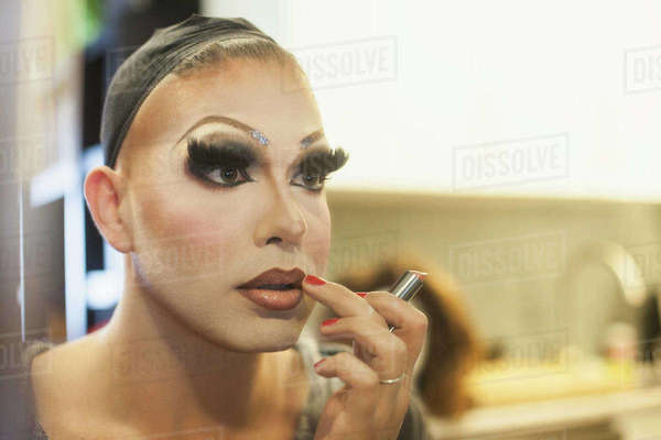 Young man applying drag makeup - Royalty-free Stock Photo | Dissolve