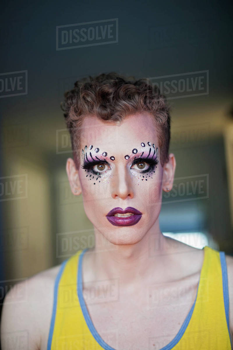 Portrait of a young man in drag makeup - Stock Photo - Dissolve