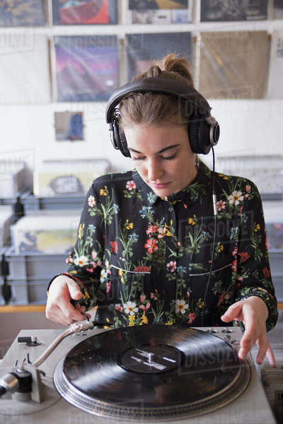 Young woman listening to record in a record store - Royalty-free Stock ...