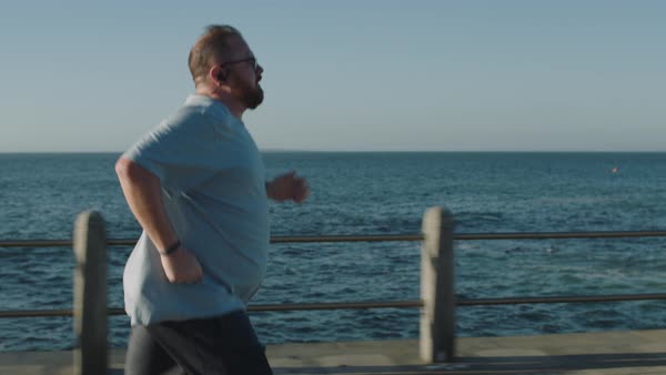Overweight man running intense workout challenge Caucasian male jogging ...