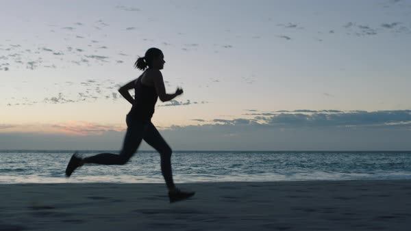 Fit young woman athlete running overtaking in race competition female ...