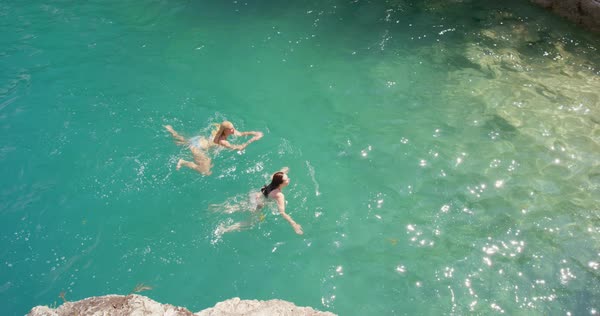 Young women swimming in lake clear blue water bright sunny summer day ...
