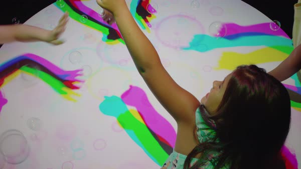 Colorful hands popping bubbles children having fun playing with ...