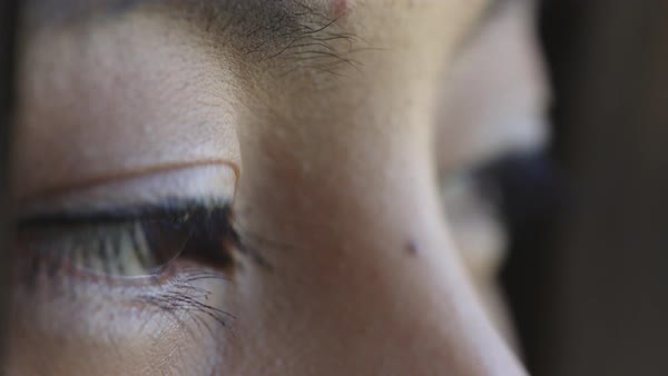 Close up young woman eyes looking pensive contemplative blinking ...