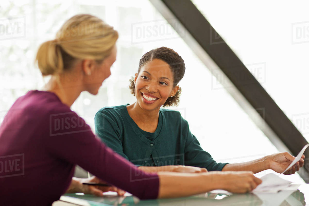 Happy colleagues working together on a project. - Stock Photo - Dissolve