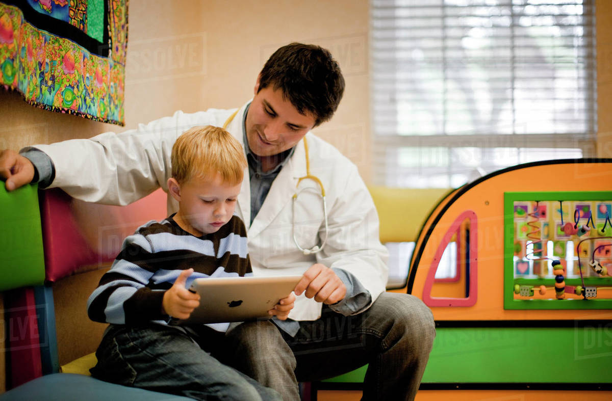 Doctor showing the tablet to his young patient. - Royalty-free Stock ...