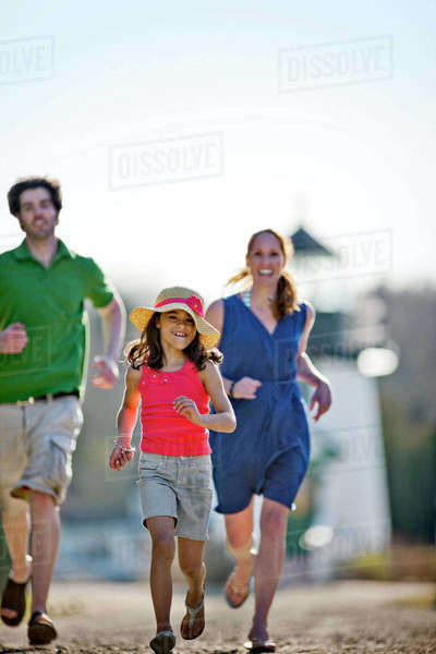 Happy family run together. - Royalty-free Stock Photo | Dissolve