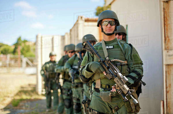 Group of police officers about to enter a building during an exercise ...