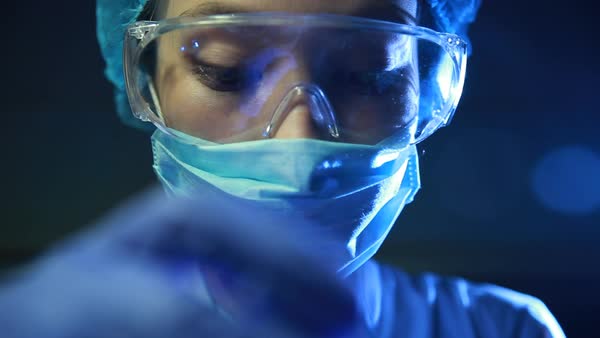 Young scientist conducting an experiment - Stock Video Footage - Dissolve