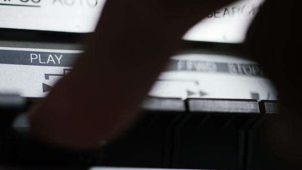 Close up of Play button being pressed on a retro stereo cassette player ...