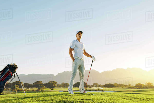 Full length of male golfer on golf course waiting to tee off. Man ...