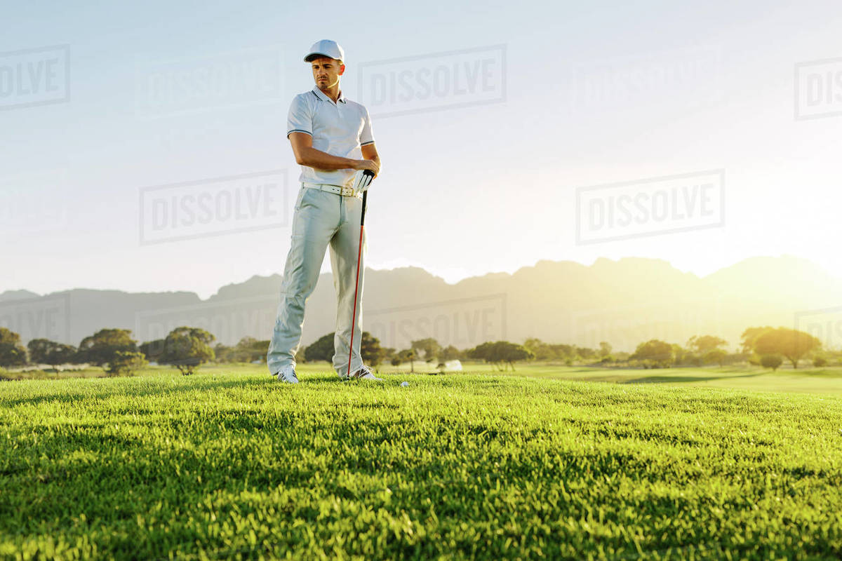 Full length of young man standing on golf course on a summer day. Male ...