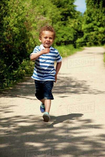 Portrait of a little boy running and having fun on a sunny day - Stock ...