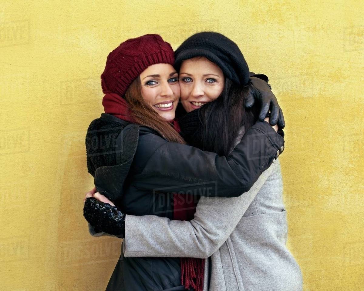Two friends giving each other a warm hug - Stock Photo - Dissolve