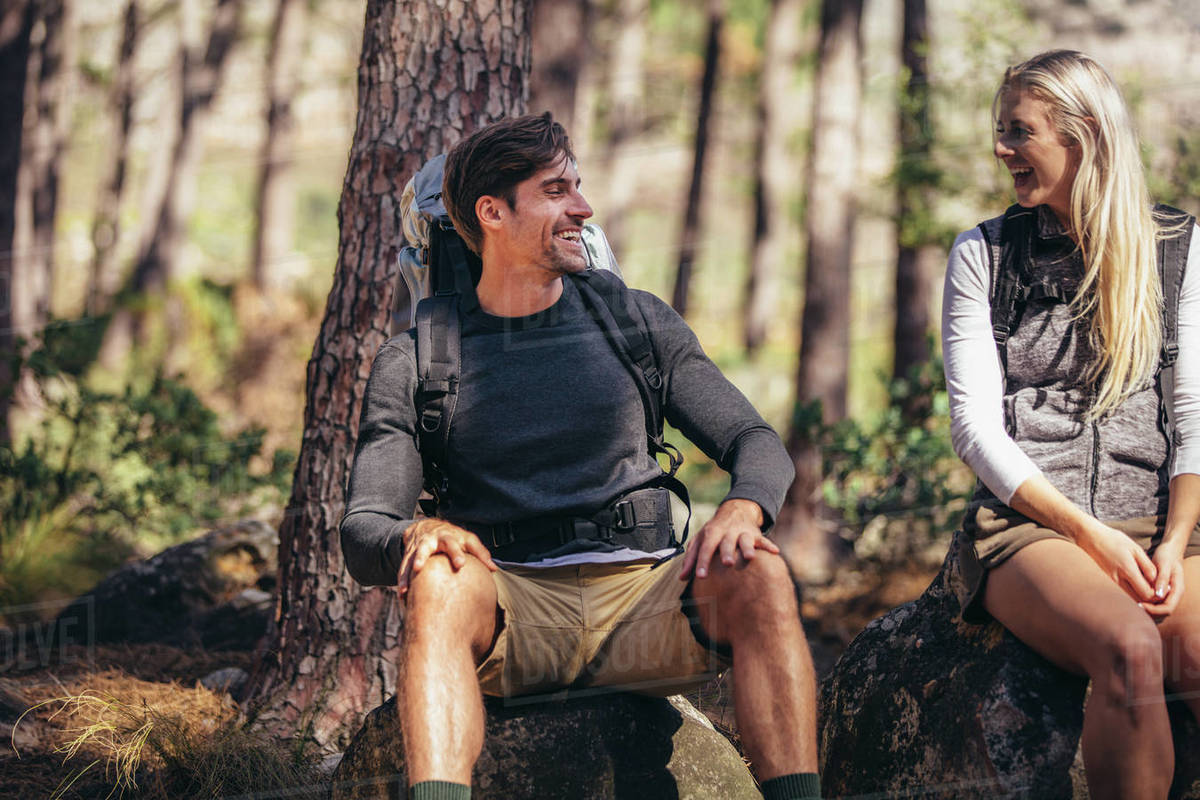 Man And Woman Hikers Relaxing While Trekking In Forest Hiker Couple