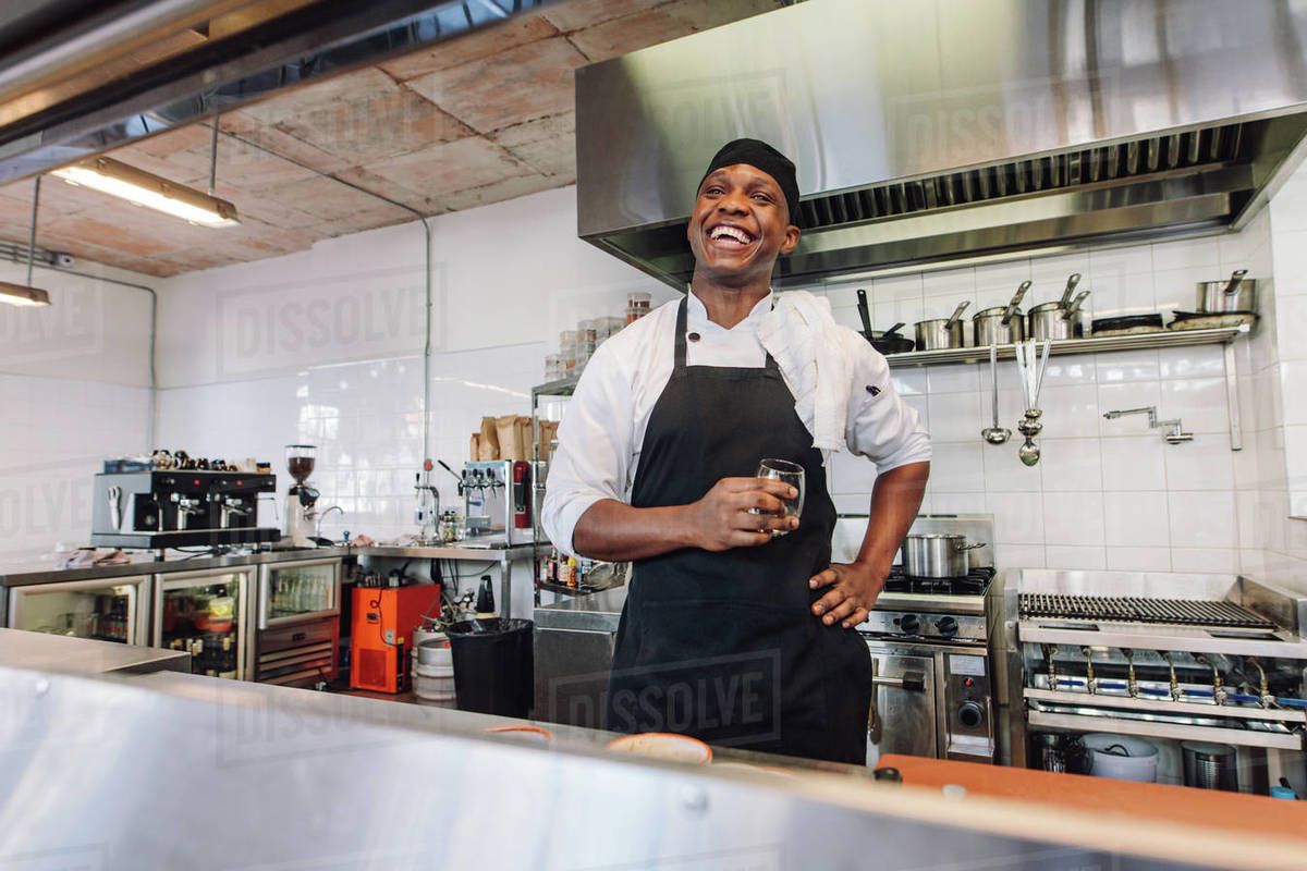 Gourmet chef taking a break from cooking at restaurant kitchen. Male ...