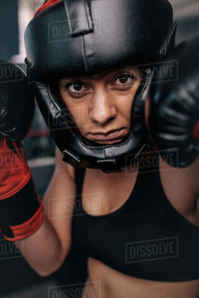 Close up portrait of a female boxer in her boxing gear. Woman boxer at ...
