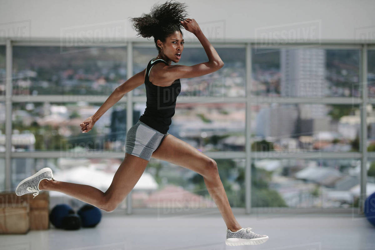 Fitness woman exercising at gym. Female doing intense physical workout ...