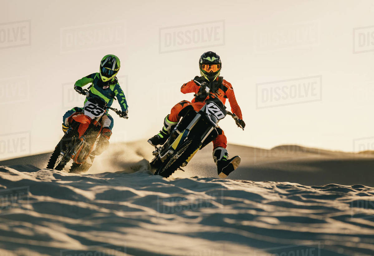 Two dirt bikers racing on the sand dune. Off roading competition in ...