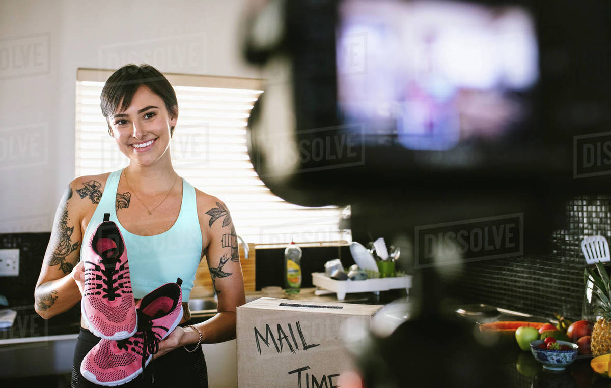 Female vloggers making video at home about sports shoes. Woman vlogger ...
