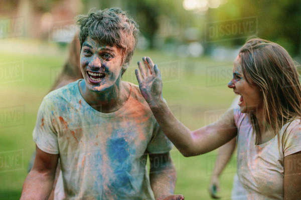 Friends playing with colored powder in a park - Royalty-free Stock ...
