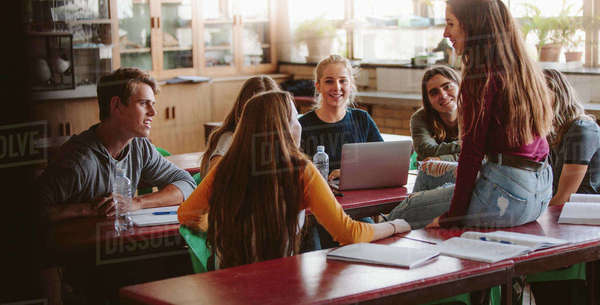 Group of young people sitting in the classroom and talking. University ...