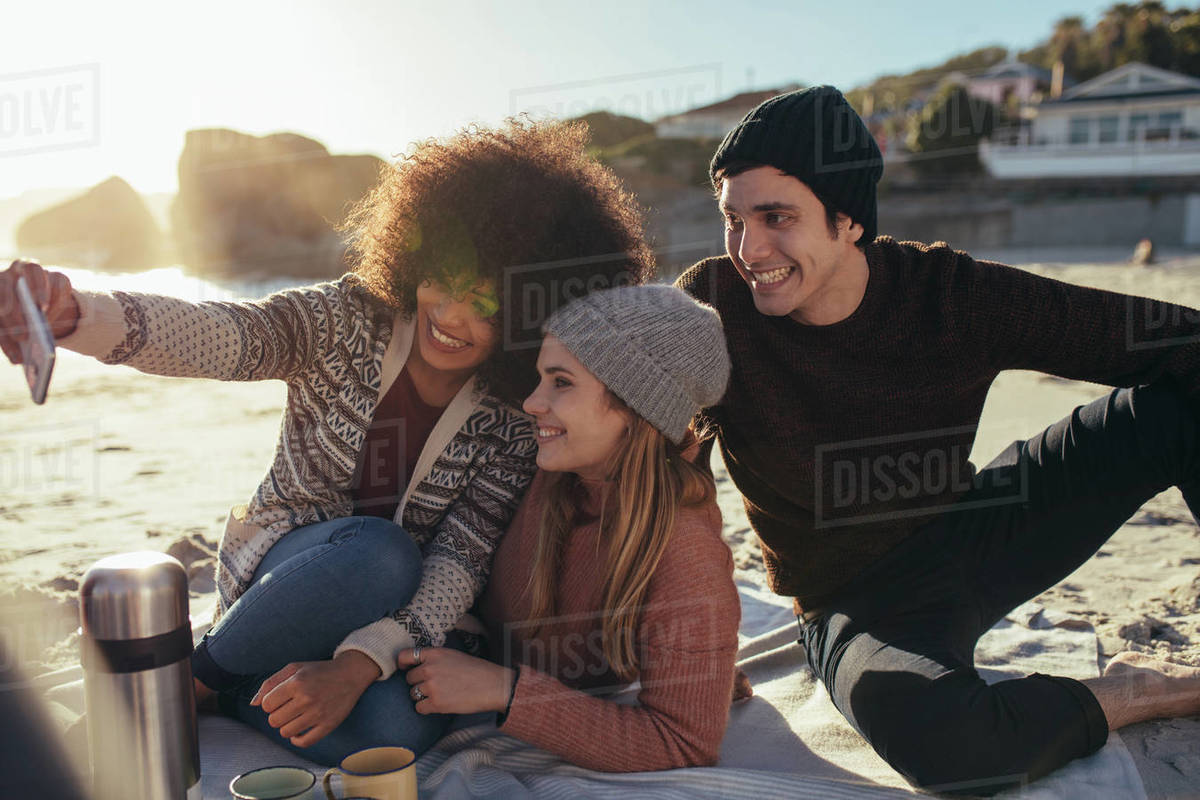 Group of happy friends having fun together and taking selfie using ...