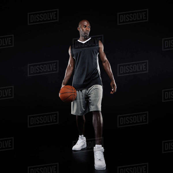 Full length portrait of young professional basketball player standing ...