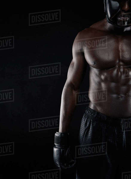 Strong body of african male boxer against black background with copy ...