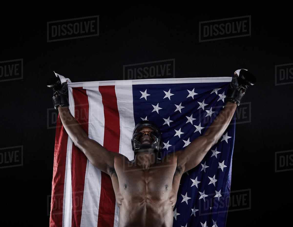 Young boxer carrying american flag raised in victory on black ...