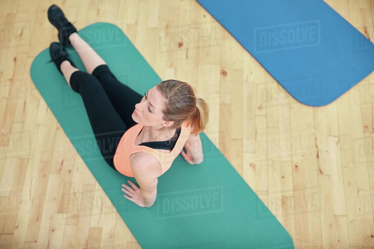 Top view of fitness woman exercising on a fitness mat . Fit woman ...