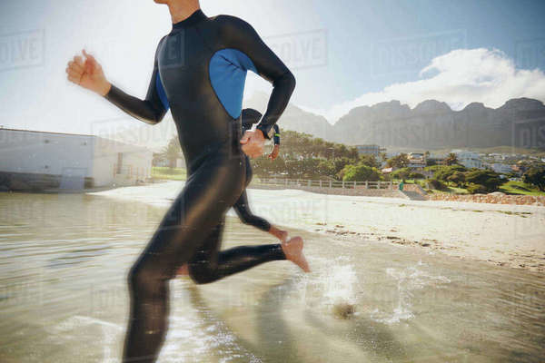 Image of two triathletes rushing into the water. Athlete running into ...