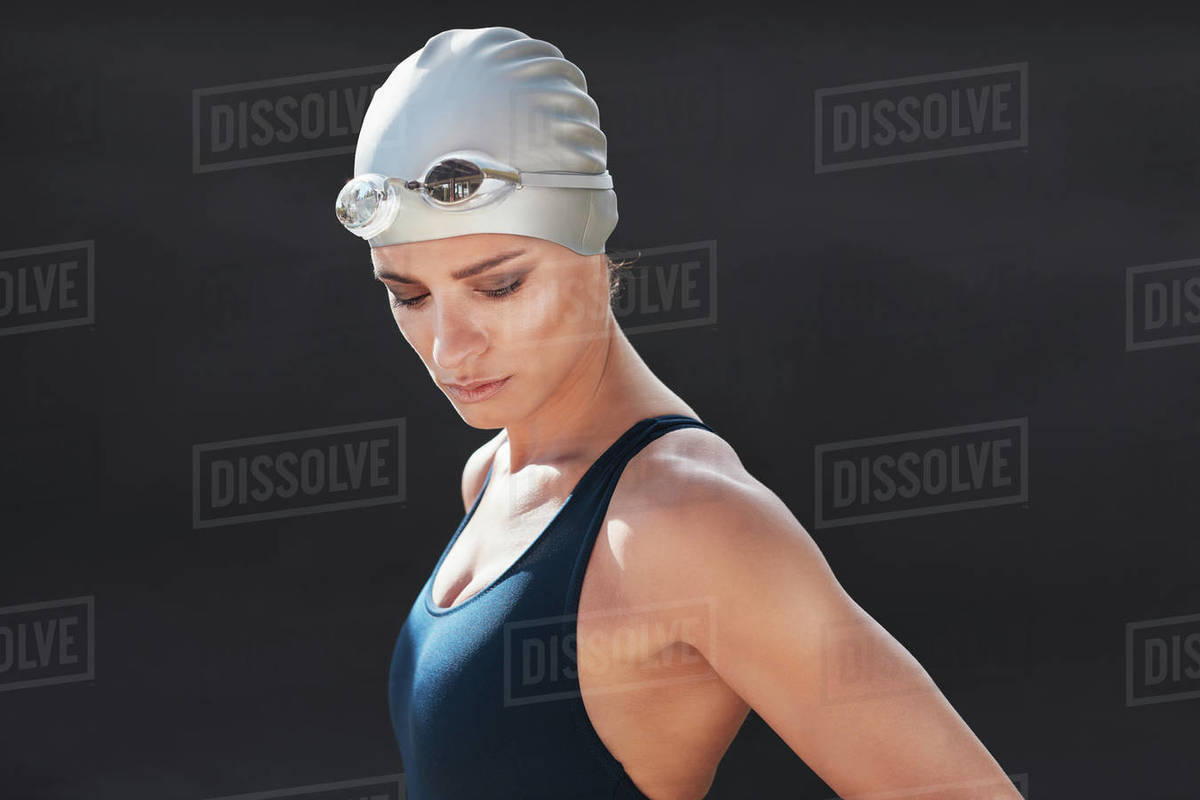 Portrait of fitness model in swimwear over black background. Female ...