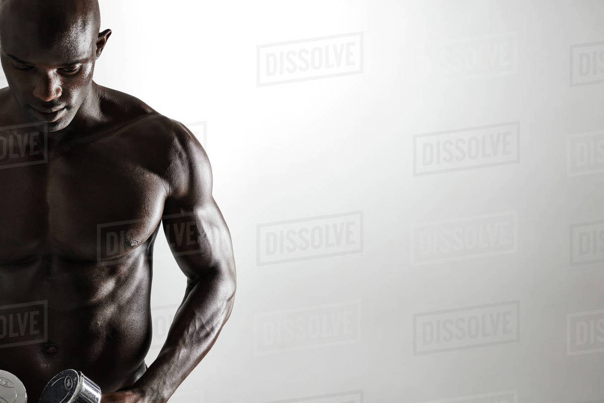 Cropped shot of healthy muscular young man holding dumbbells against ...