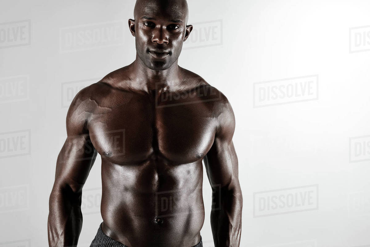 Portrait of masculine young african male model posing shirtless against ...